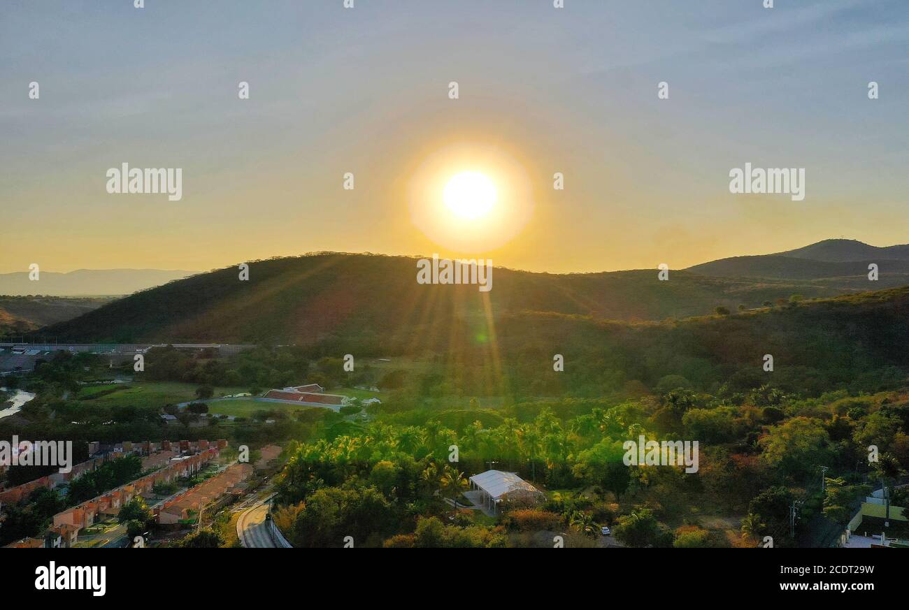 Sunset between mountains in the village Stock Photo - Alamy