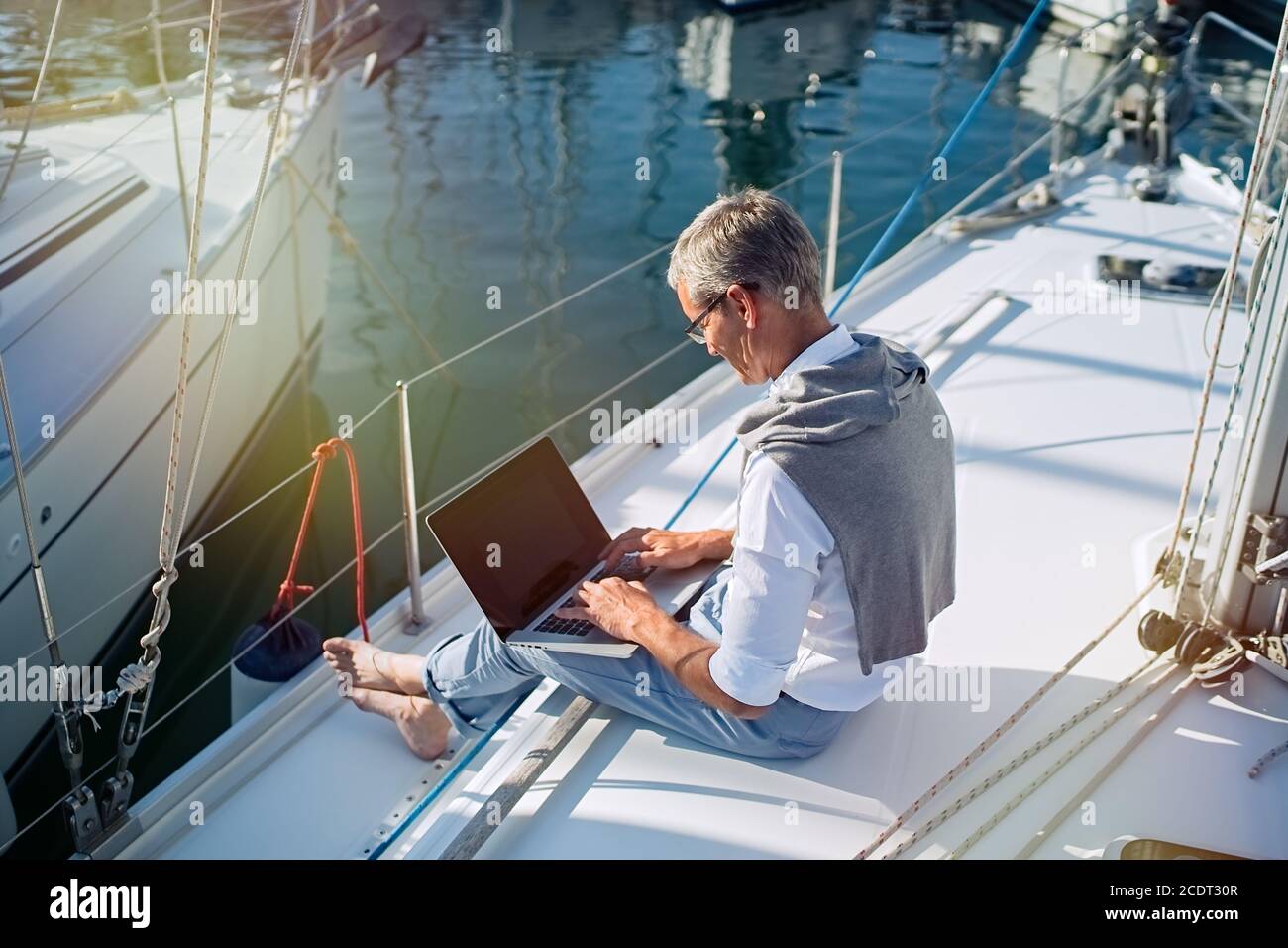 Businessman working computer on boat hi-res stock photography and ...