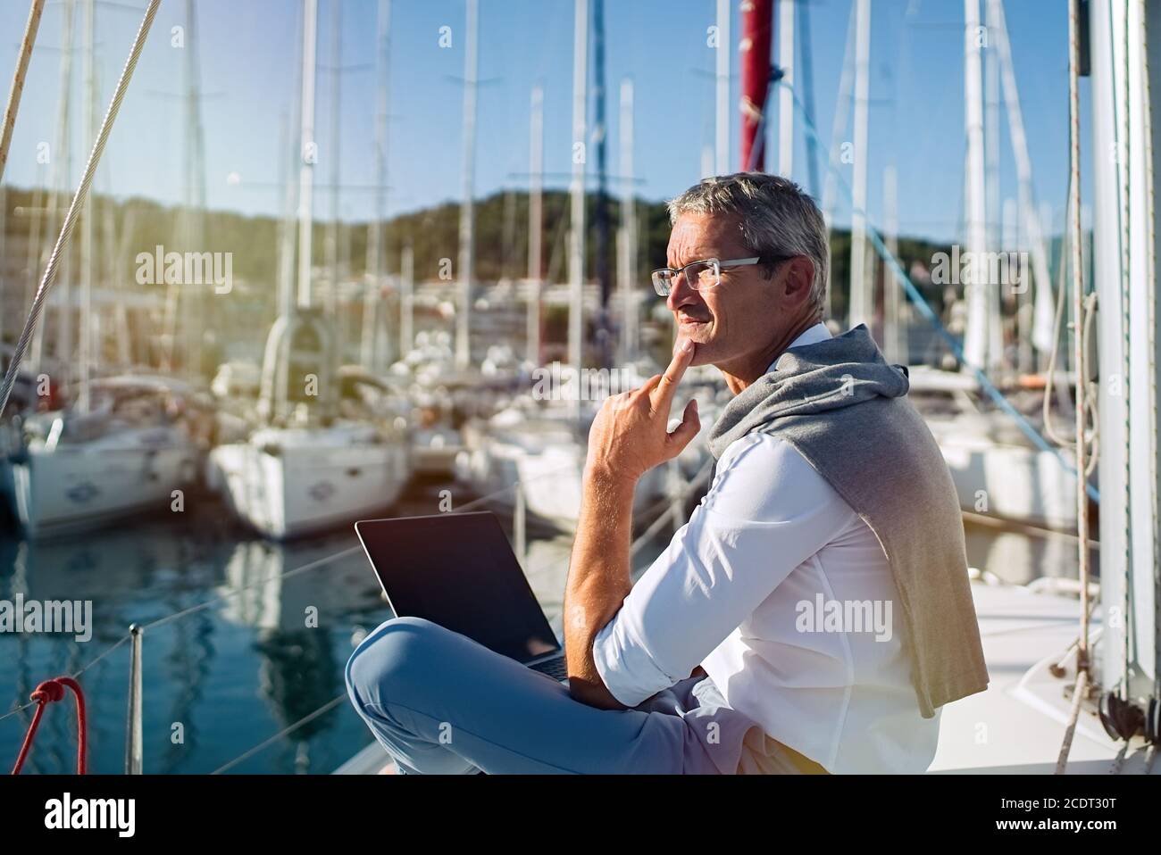 Businessman working computer on boat hi-res stock photography and ...