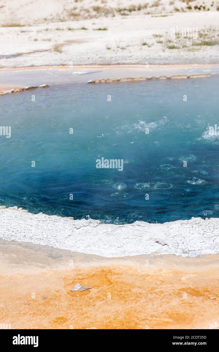 Deep blue boiling water inside of Crested Pool with a white rim at ...