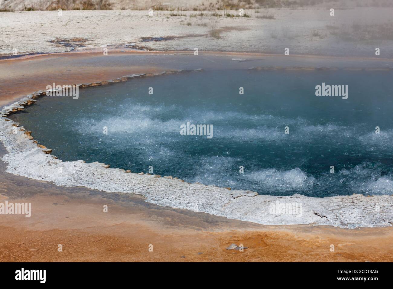 Deep blue boiling water inside of Crested Pool with a white rim at ...