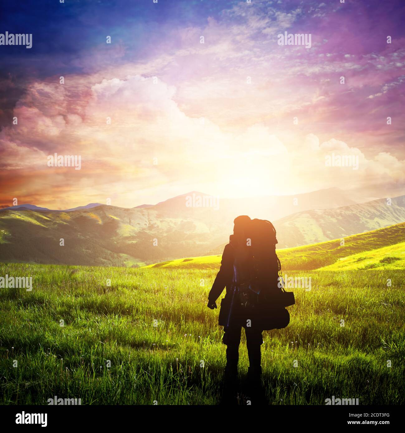 Man with backpack trekking on highlands. Fantastic sunset sky, summer ...