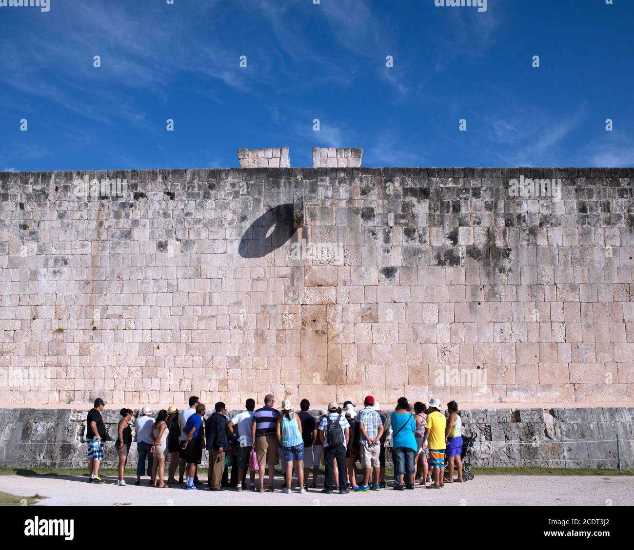 A group of tourists at the site of a ball game court at the ancient ...