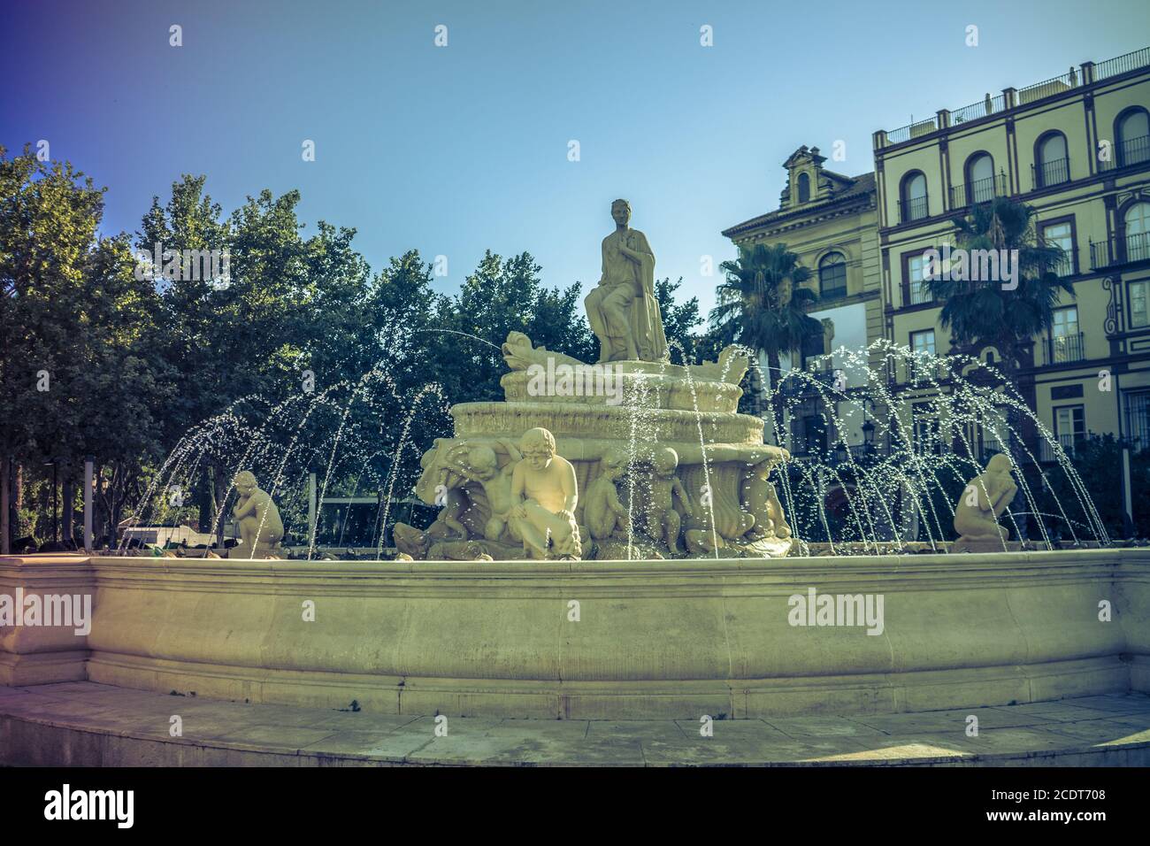 Water fountain with a statue in a main square in Seville, Spain, Europe ...