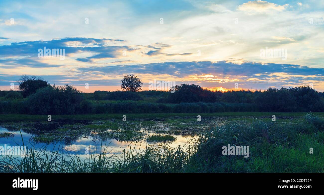 Sunset and pond Stock Photo - Alamy