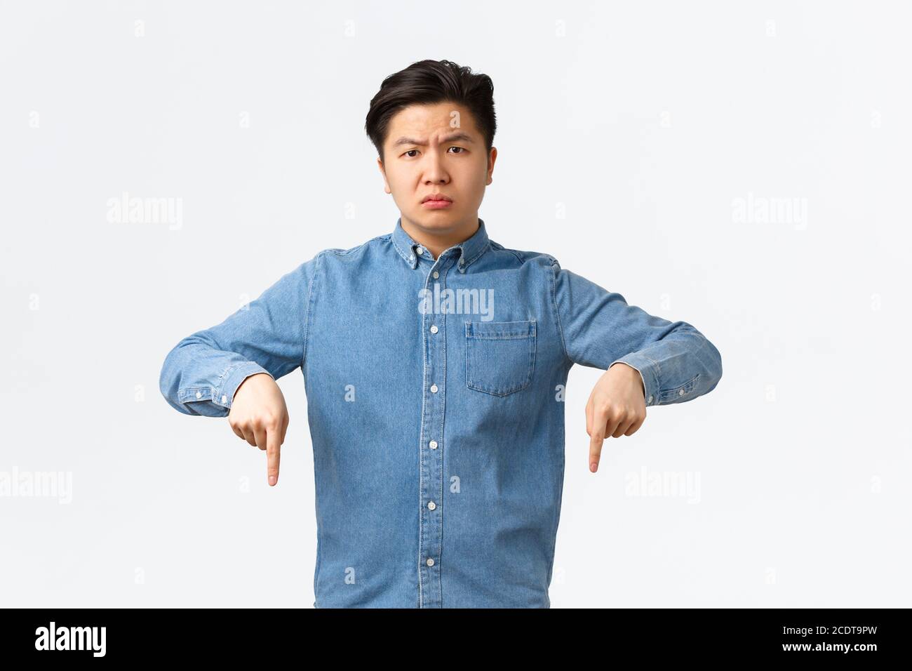 Disappointed and upset young asian guy complaining, looking concerned ...