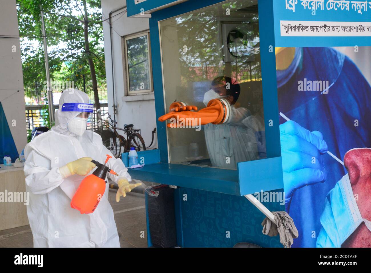 Health worker sprays disinfectant after a lab technician collected a ...