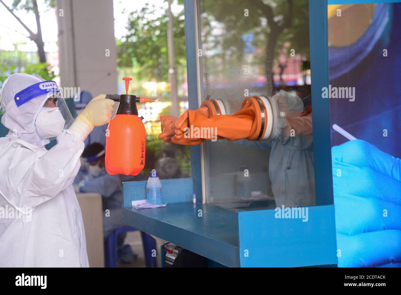 Health worker sprays disinfectant after a lab technician collected a ...