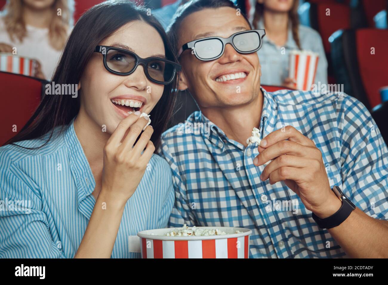Young people friends together in the cinema Stock Photo - Alamy