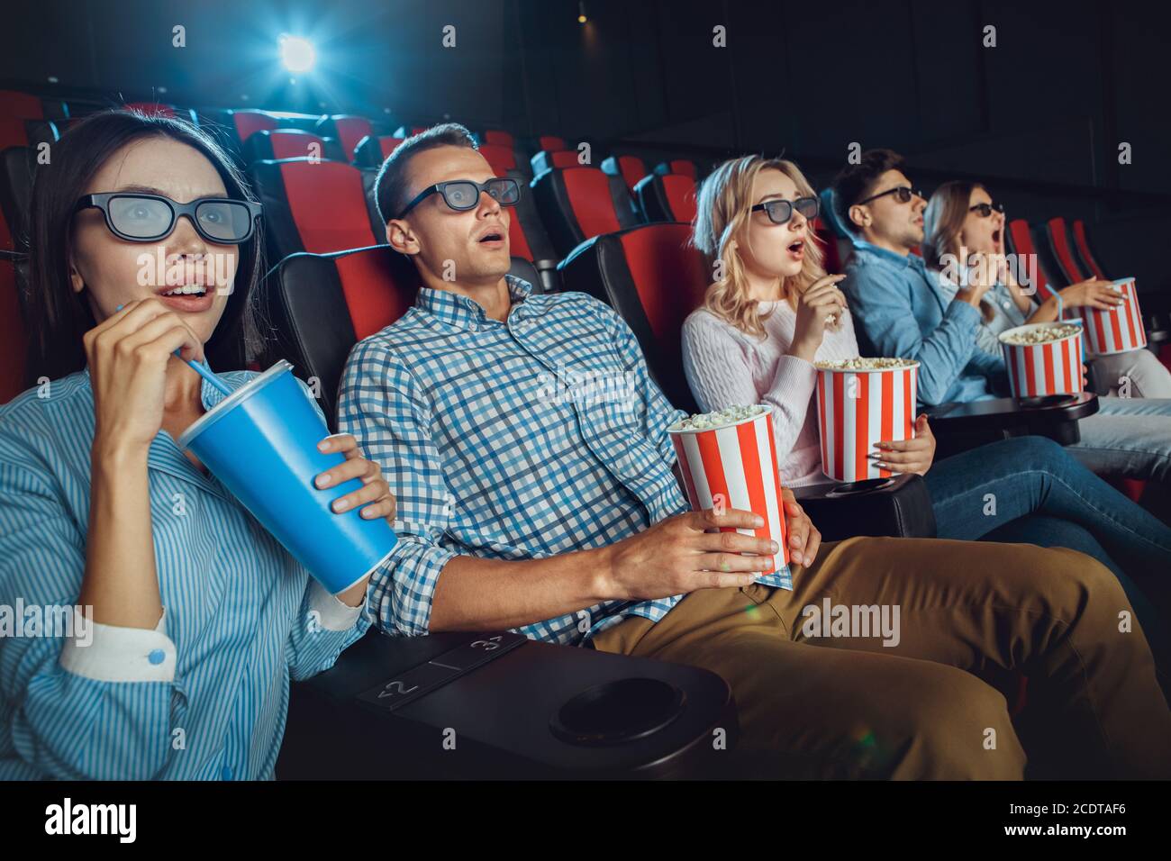 Young people friends together in the cinema Stock Photo - Alamy