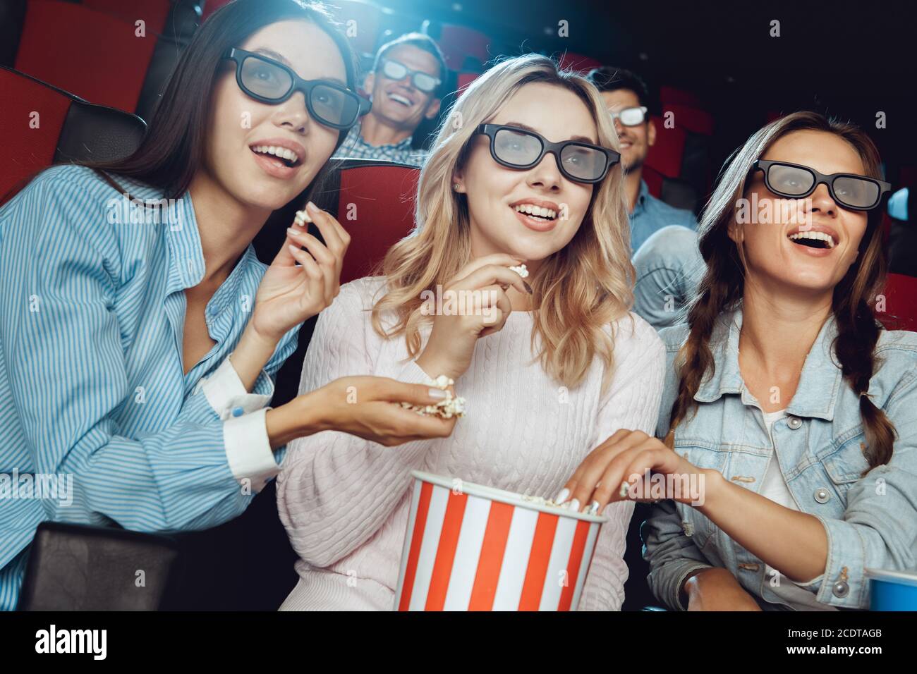 Young people friends together in the cinema Stock Photo - Alamy