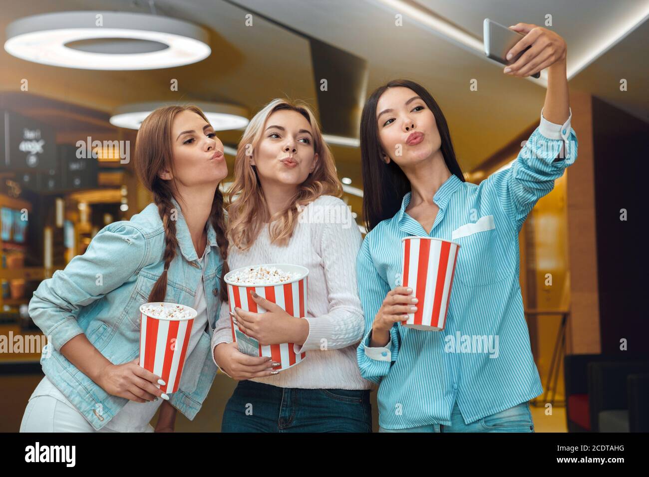 Young people friends together in the cinema Stock Photo - Alamy