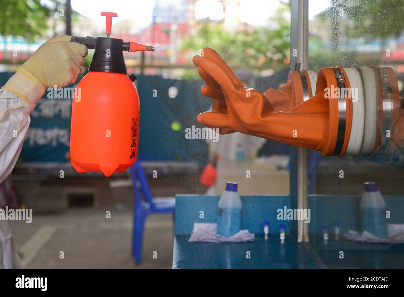 Health worker sprays disinfectant after a lab technician collected a ...