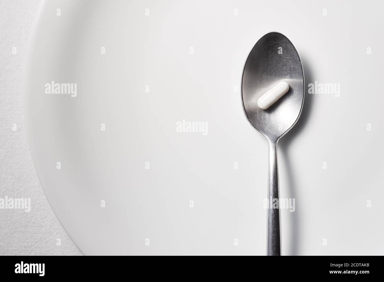 Spoon with Capsule Stock Photo - Alamy