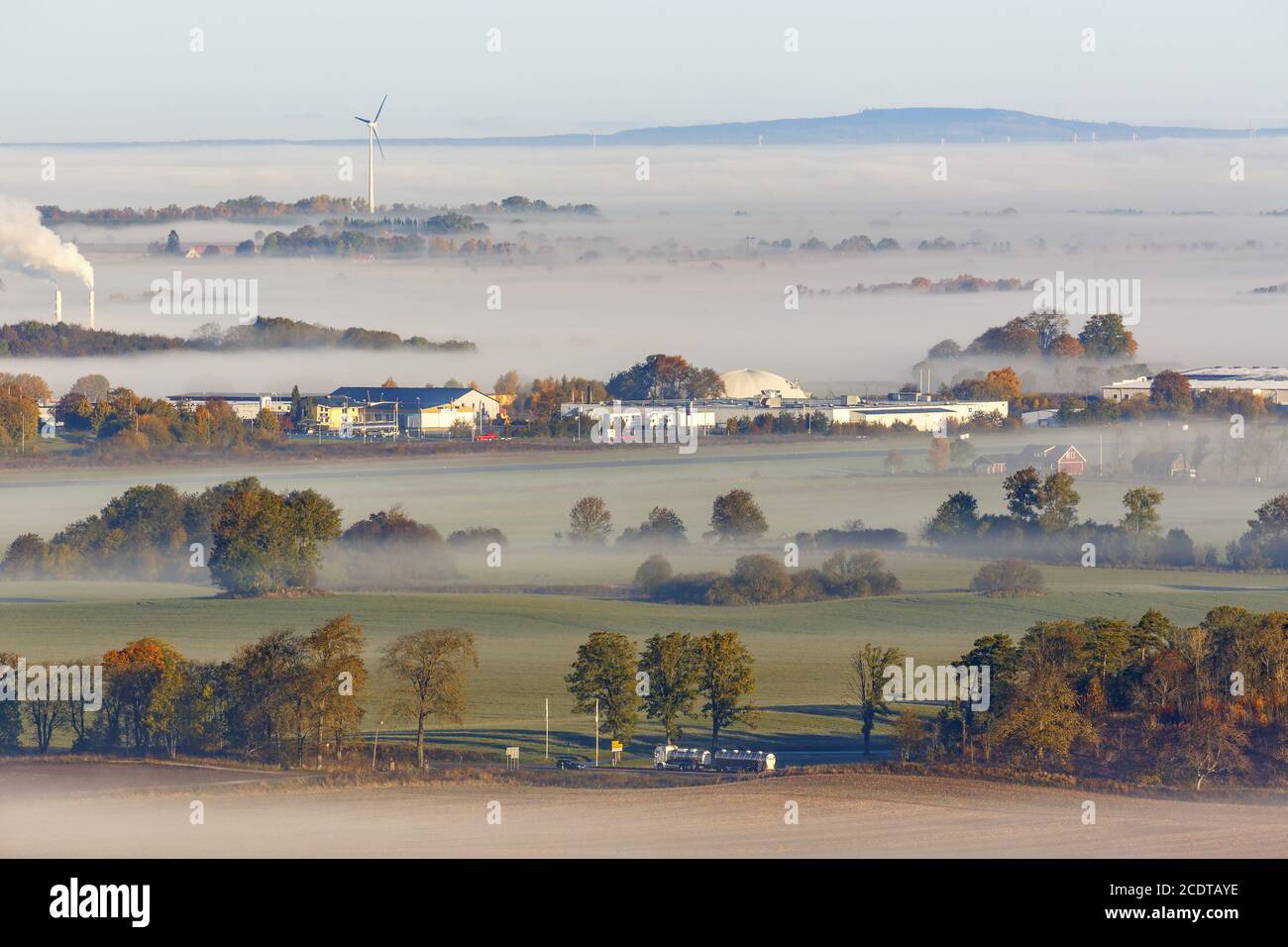 Fog over the landscape with a road and an industrial estate Stock Photo ...