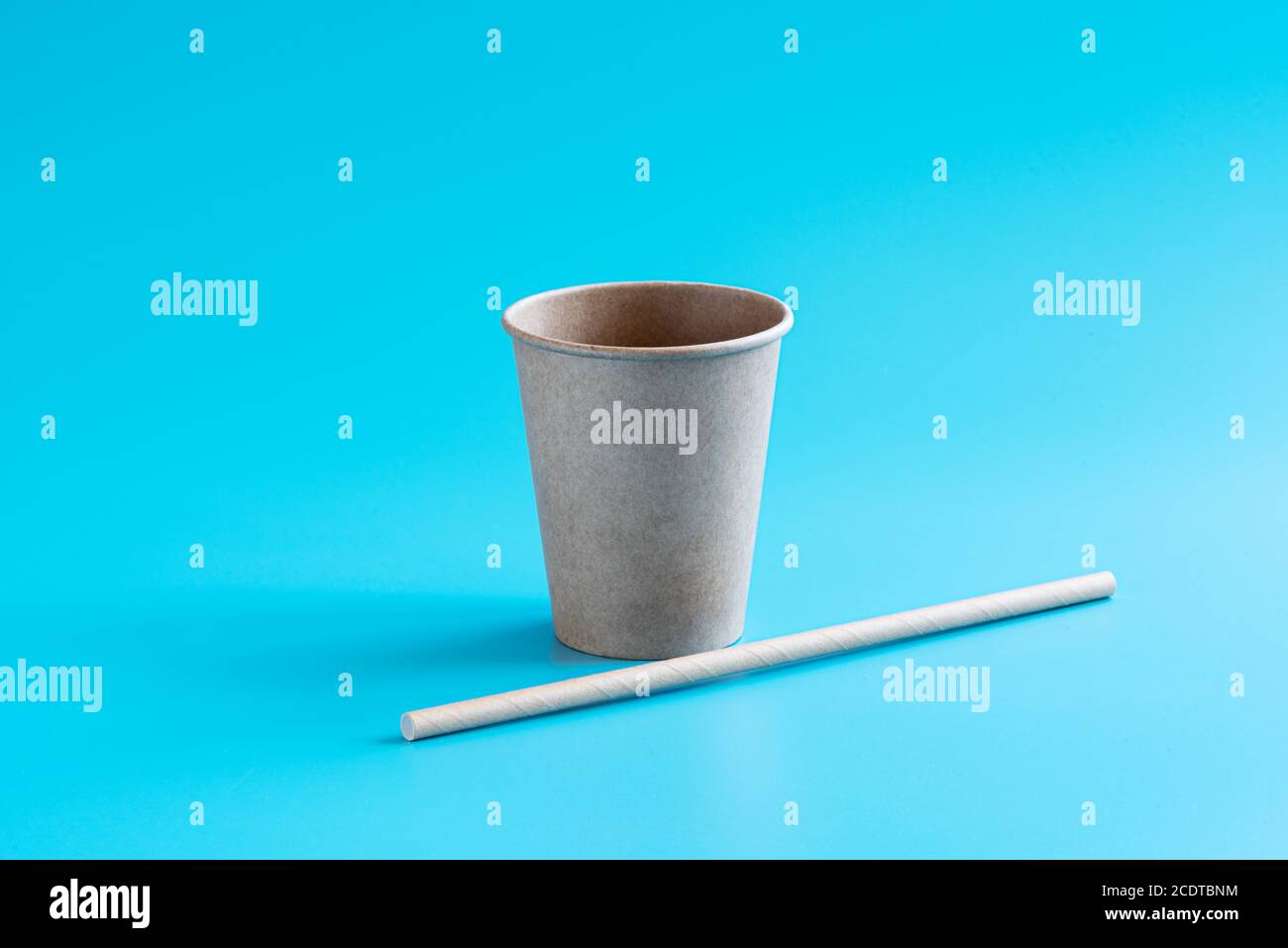 Recycled paper cup and drinking straw on blue background. Eco-friendly ...