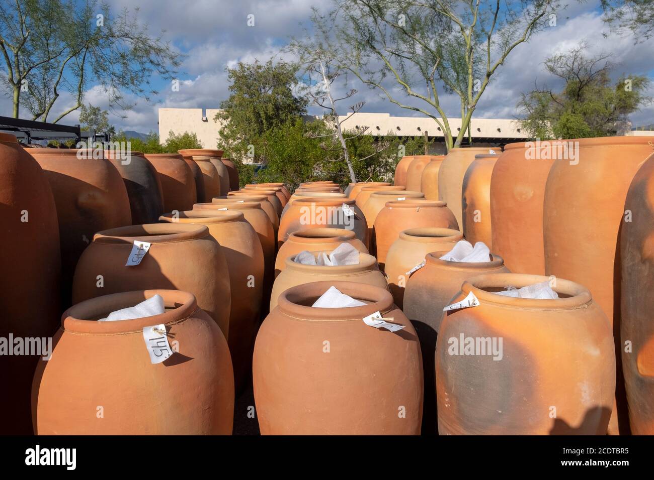Large new terracotta clay pots in rows Stock Photo - Alamy