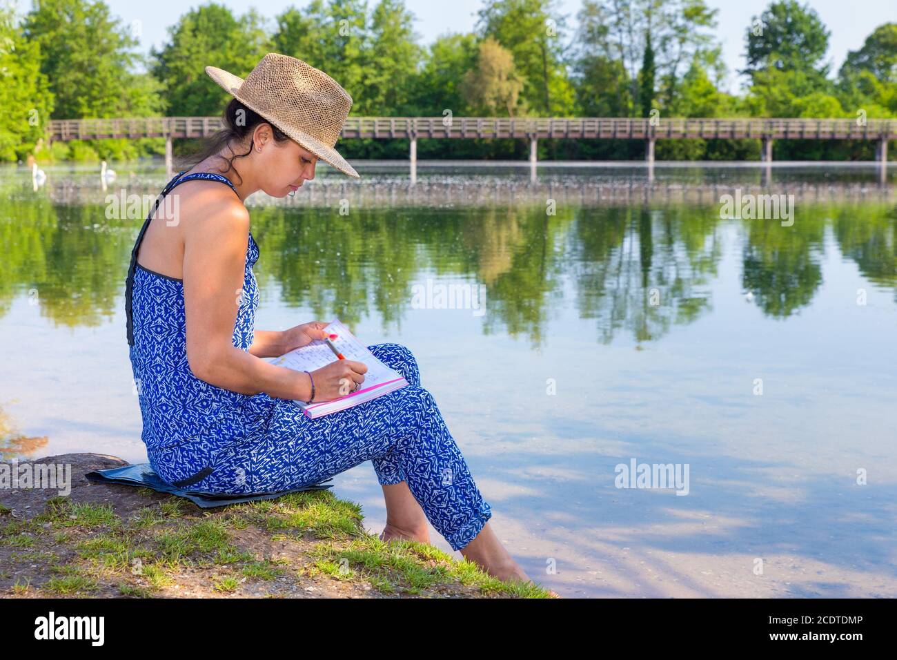 Woman sitting outside writing hi-res stock photography and images - Alamy