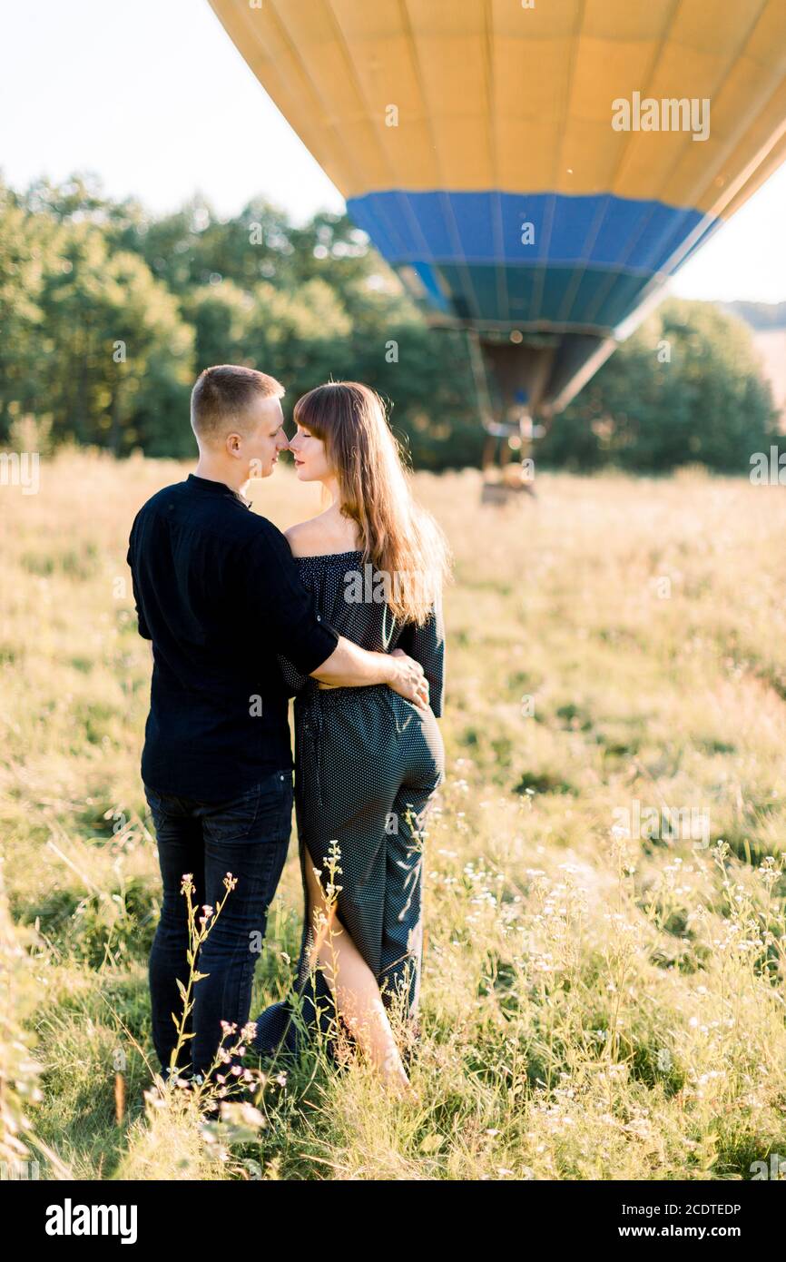 Back view of beautiful romantic couple in black stylish clothes ...