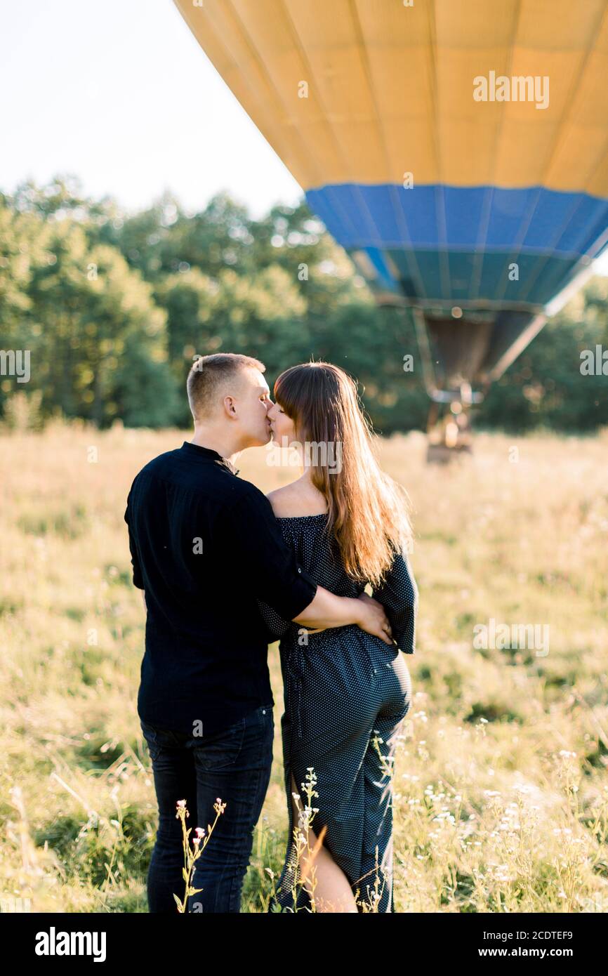 Back view of beautiful romantic couple in black stylish clothes ...