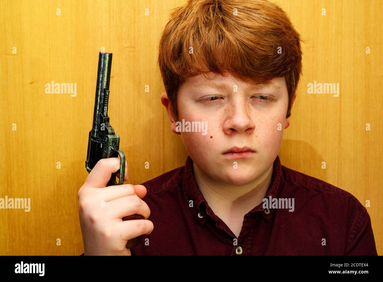 Ginger haired boy holding toy gun hi-res stock photography and images - Alamy