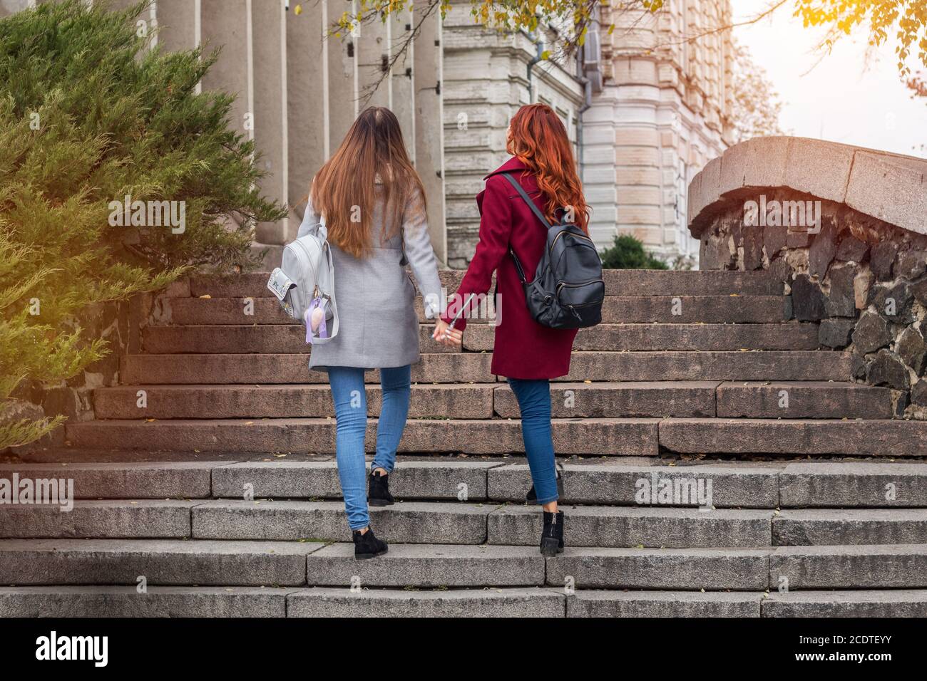 Female friends holding hands walking hi-res stock photography and ...