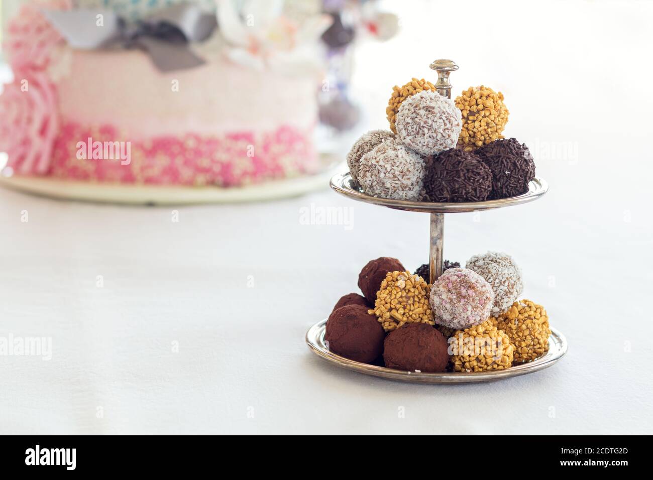 Pyramid of chocolate balls. Chocolate candies covered with icing, nuts ...
