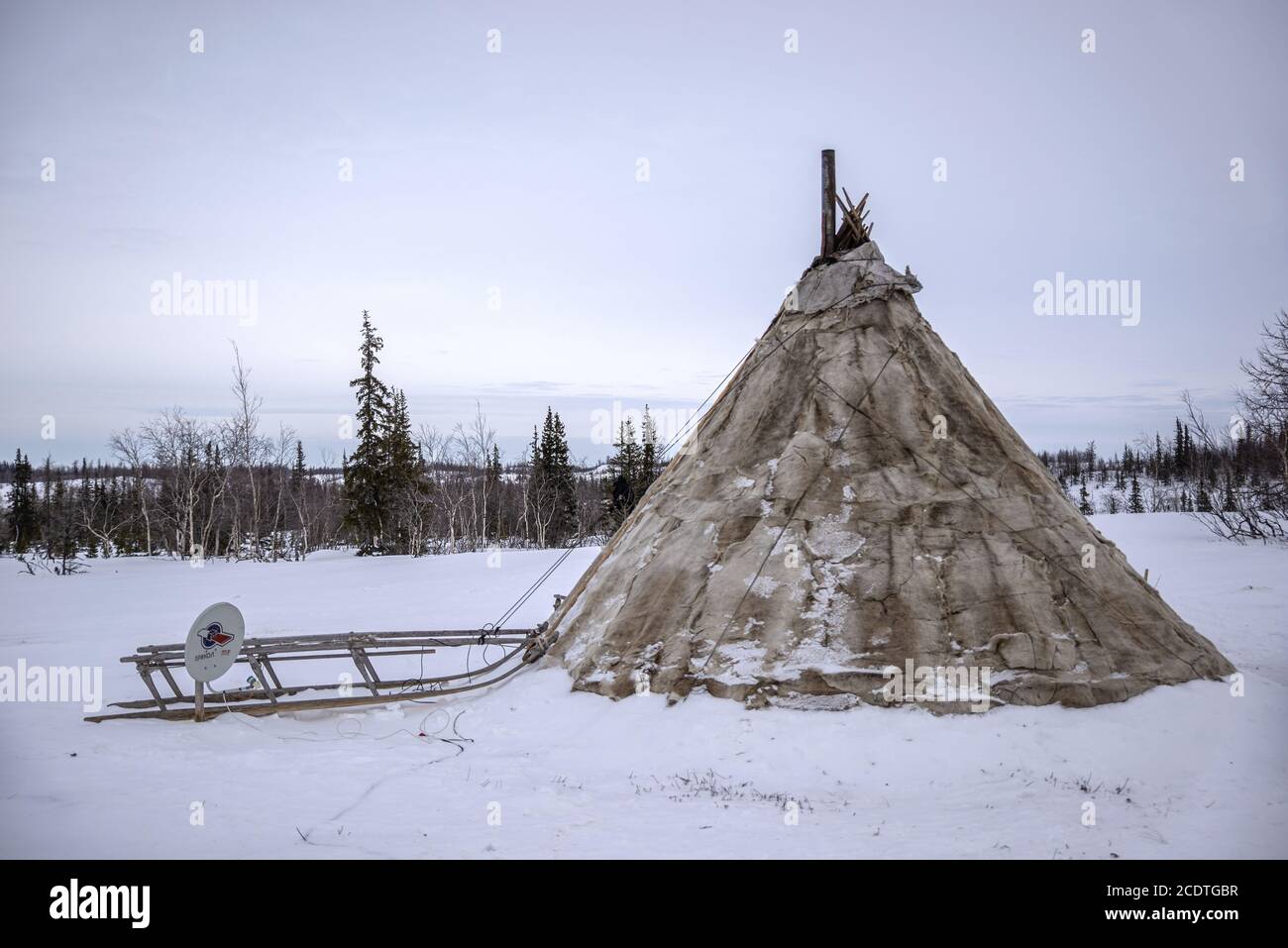 A Nenet chum (traditional tent covered with reindeer hides) and a "holy ...