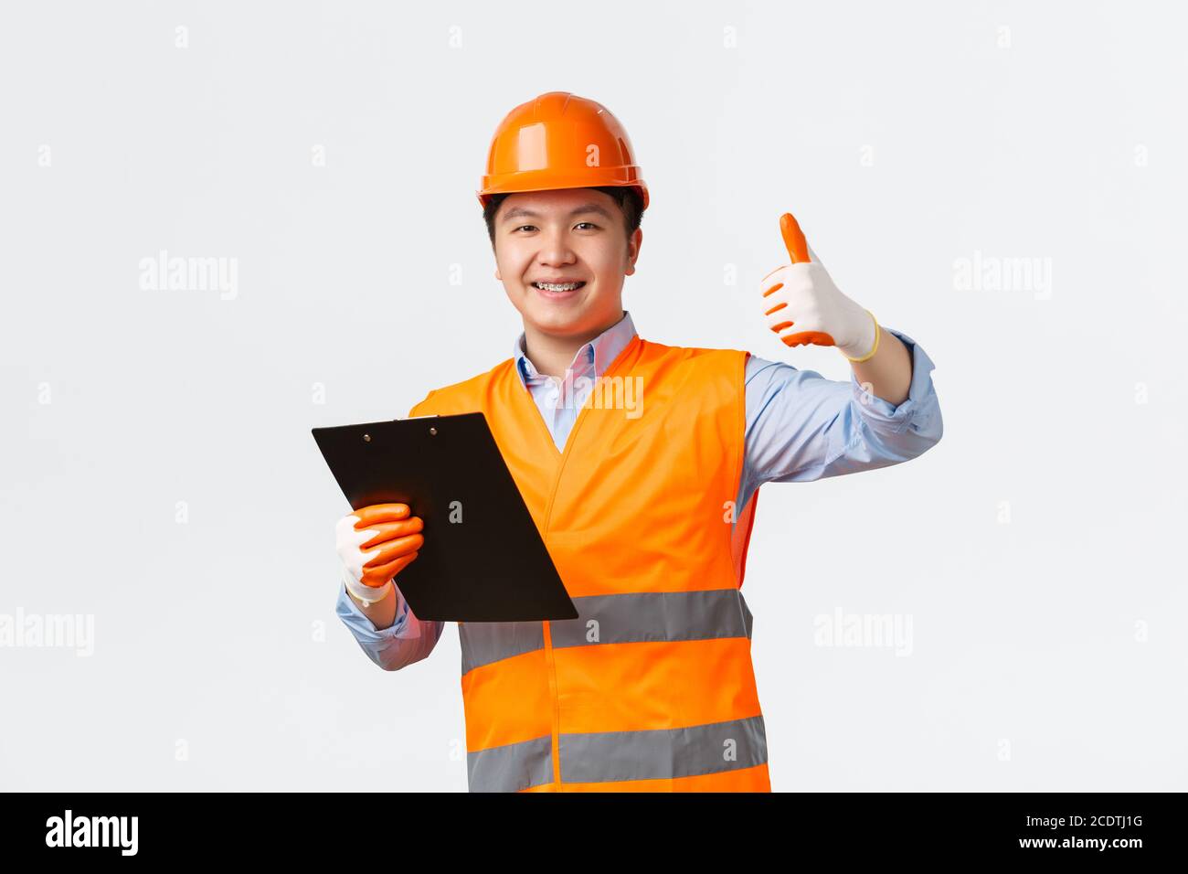 Building sector and industrial workers concept. Smiling satisfied asian ...
