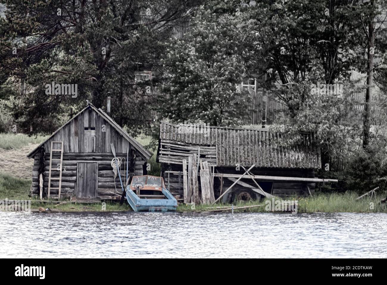 wooden house, barn of fisherman, motor boat Stock Photo - Alamy