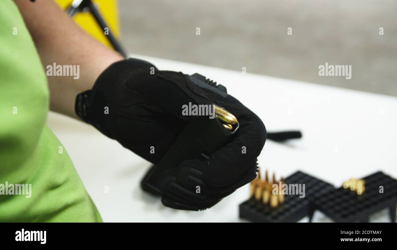 Adult loading an assault rifle at a shooting range Stock Photo - Alamy