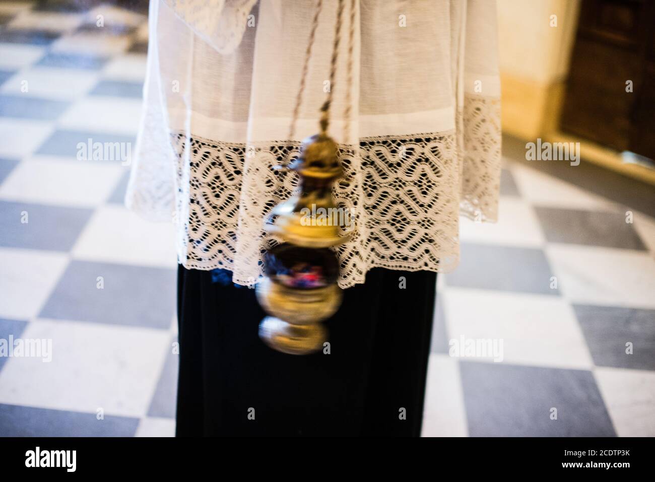 altar boy of the catholic church with thurible in his hand during a ...