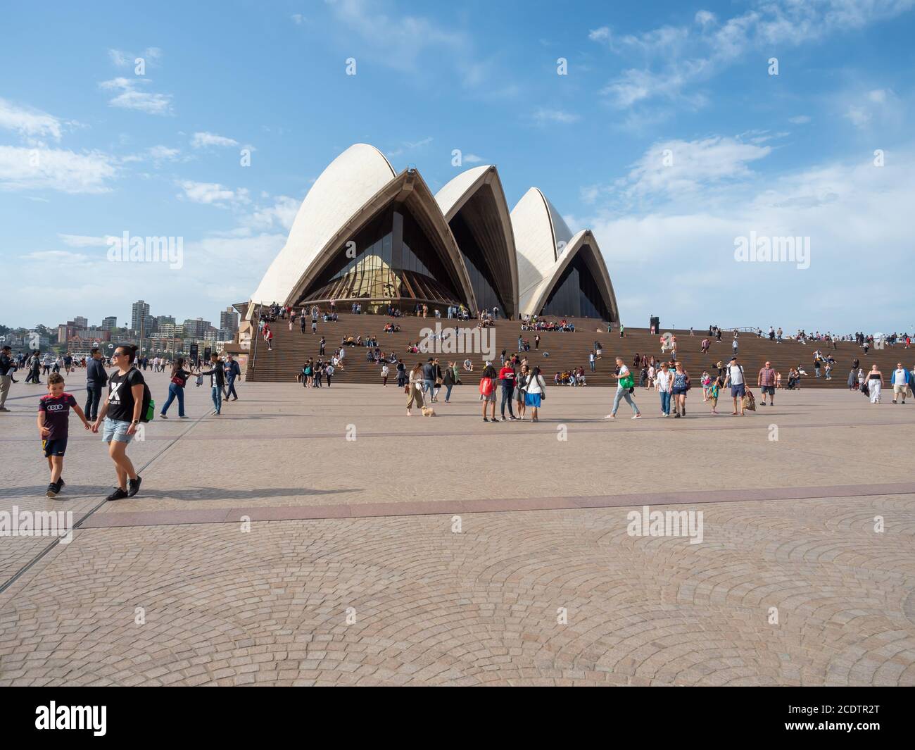 Sydney Opera House with visitors walking along the foot path on a ...