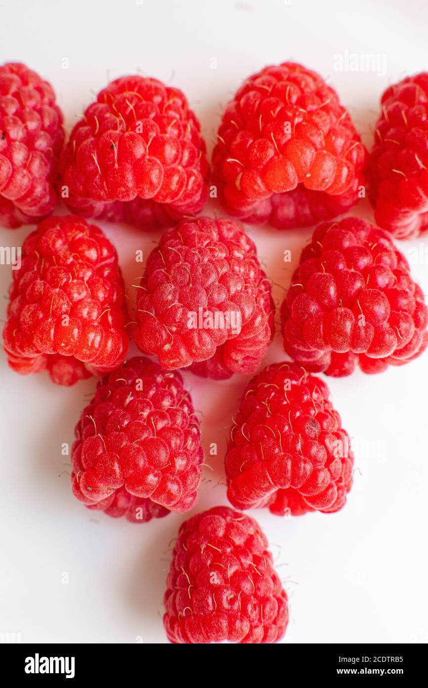 Beautiful raspberries in triangle shape lies isolated on a white ...