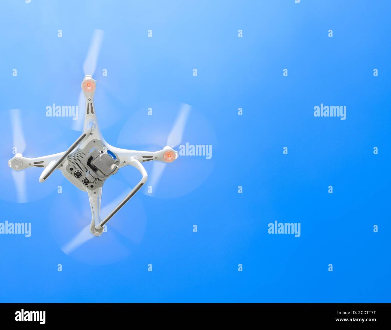 Drone DJI Phantom 4 in flight. Quadrocopter against the blue sky Stock ...