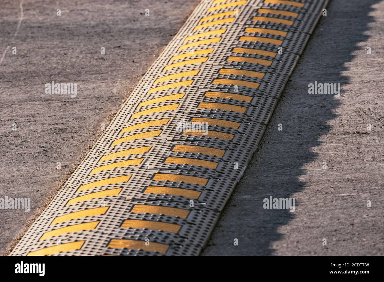 Traffic safety speed bump on the asphalt road Stock Photo - Alamy