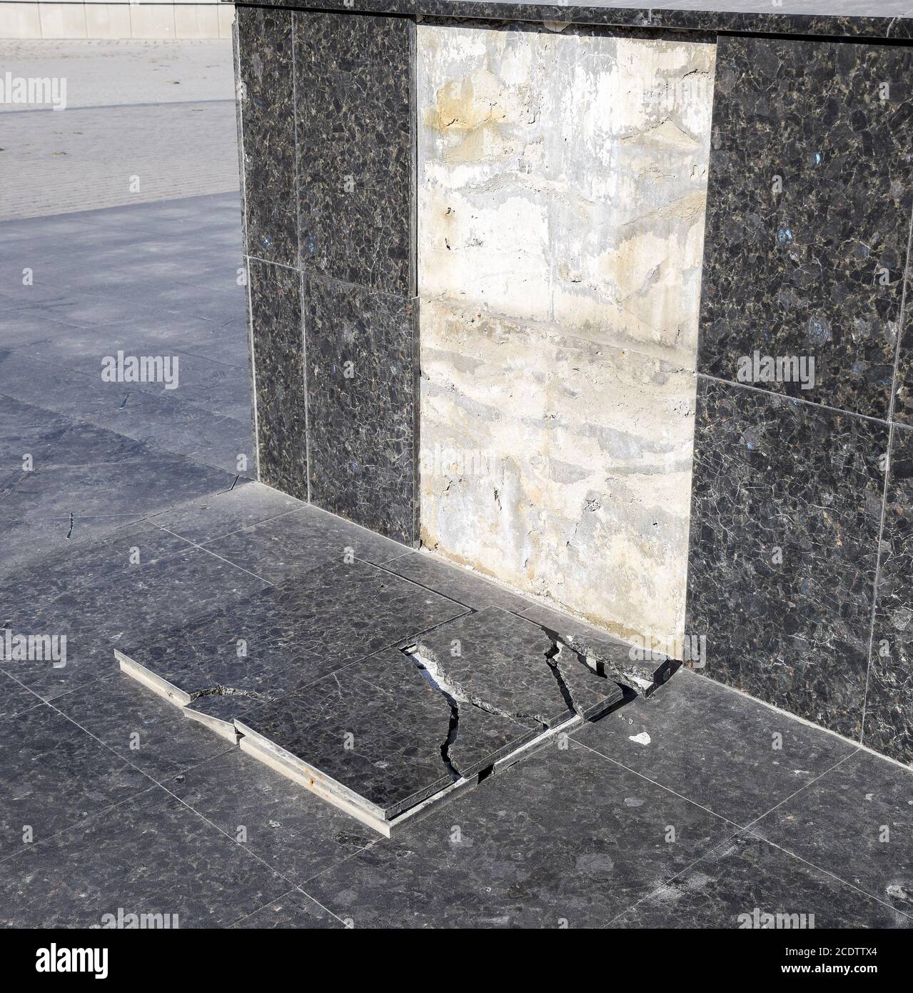 The ruined marble tile that fell off from the base of the monument ...