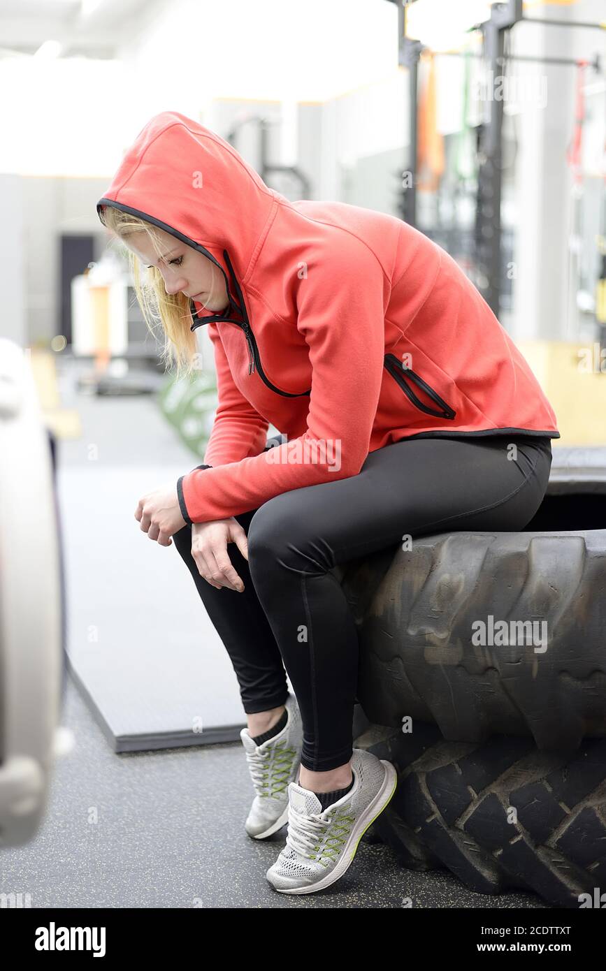 exhausted young woman in gym Stock Photo - Alamy