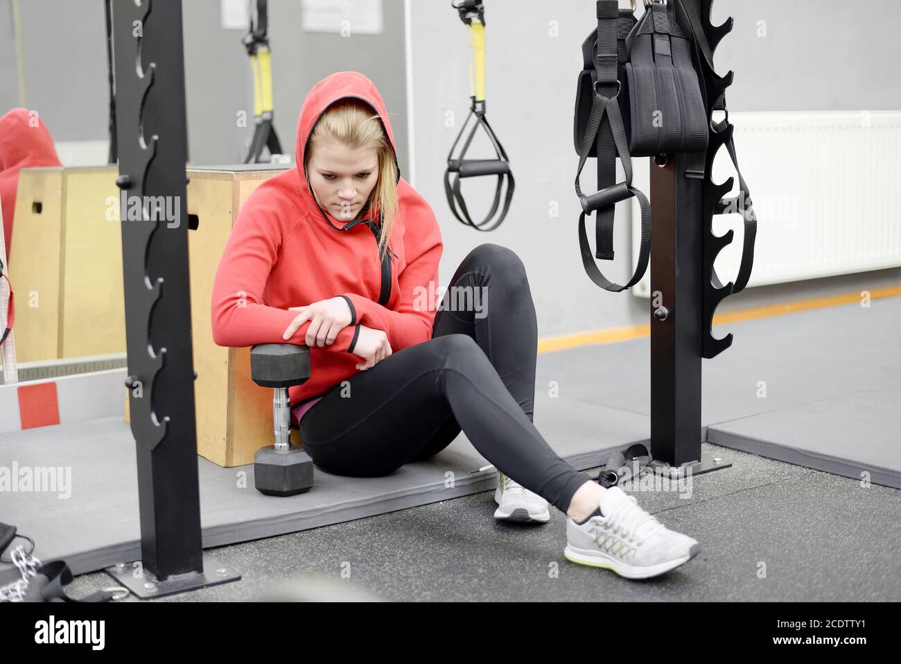 exhausted young woman in gym Stock Photo - Alamy