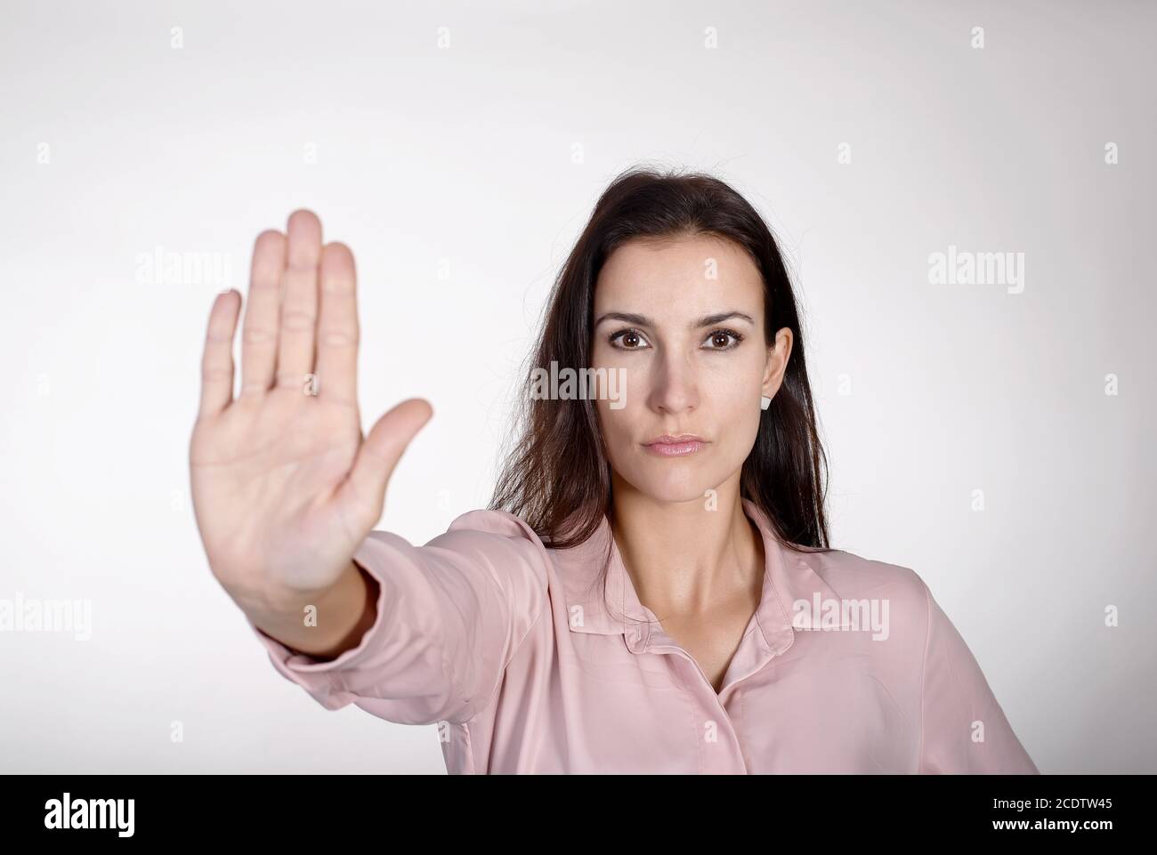 woman showing stop with one hand Stock Photo - Alamy