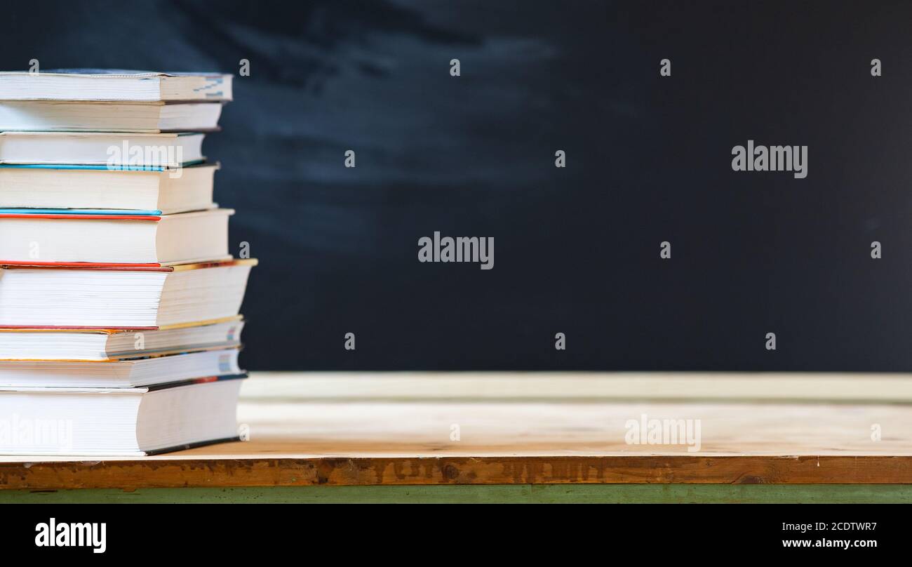 back to school concept pile of books and chalkboard Stock Photo - Alamy