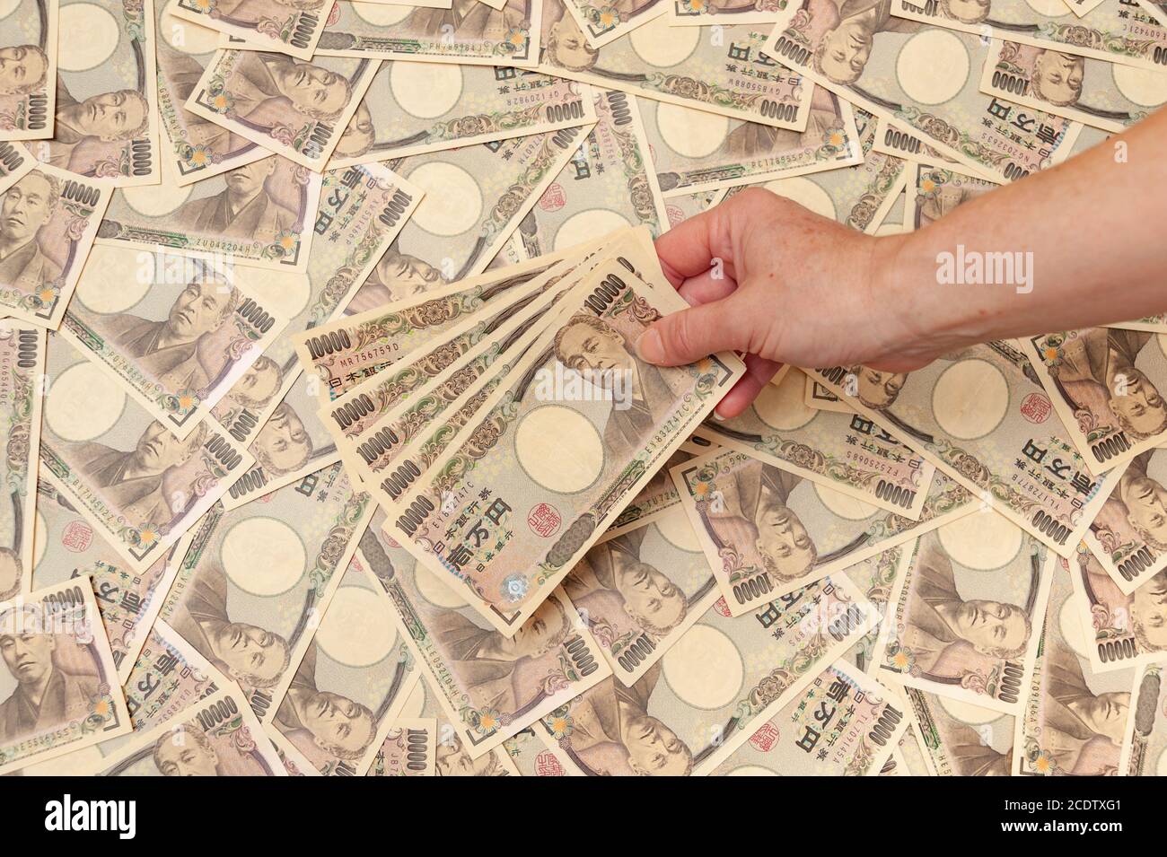 Hand Holding Five Pieces Of 10 000 Yen Notes Background With Several hand-holding-five-pieces-of-10-000-yen-notes-background-with-several