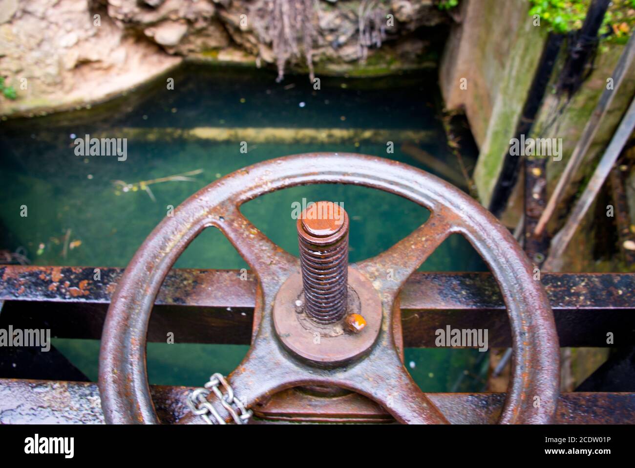 irrigation sluice system with rusty shutoff wheel Stock Photo - Alamy