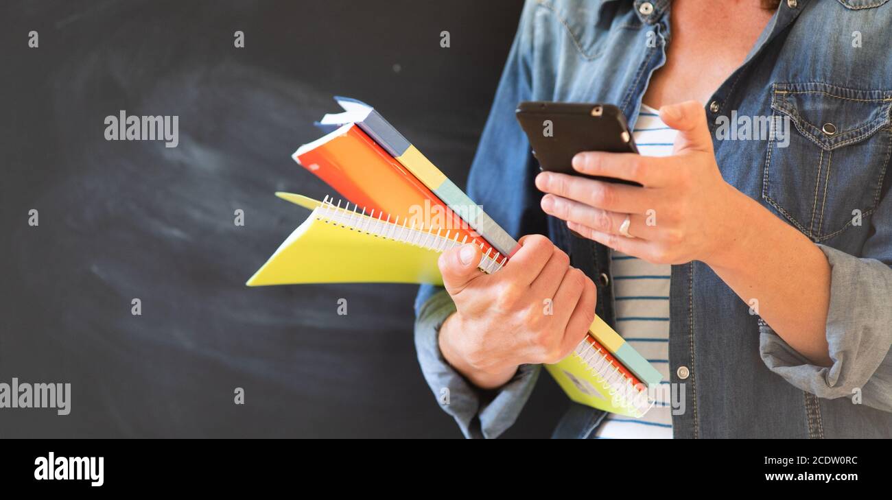 student with books and smartphone Stock Photo - Alamy