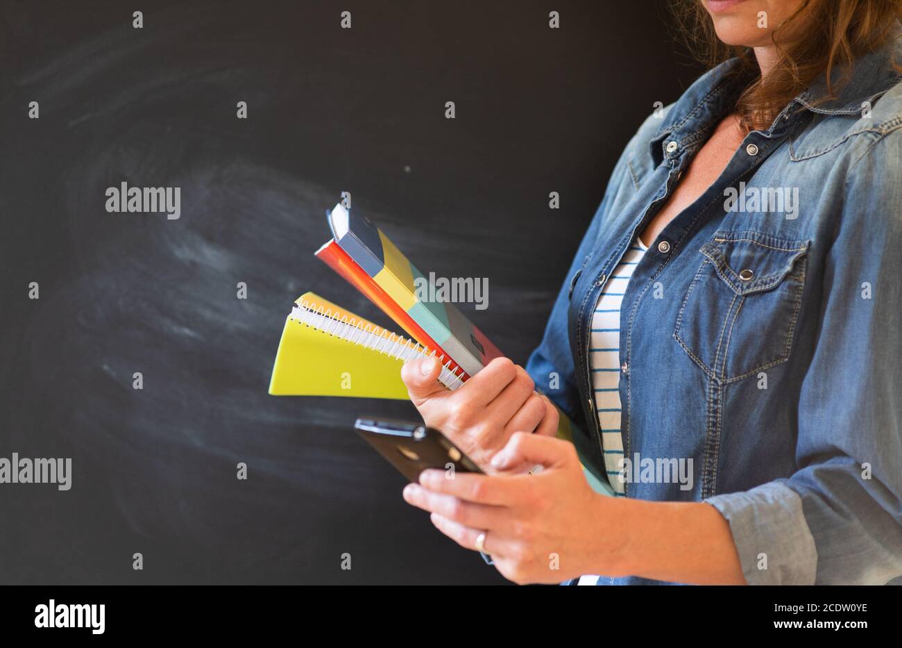student with books and smartphone Stock Photo - Alamy