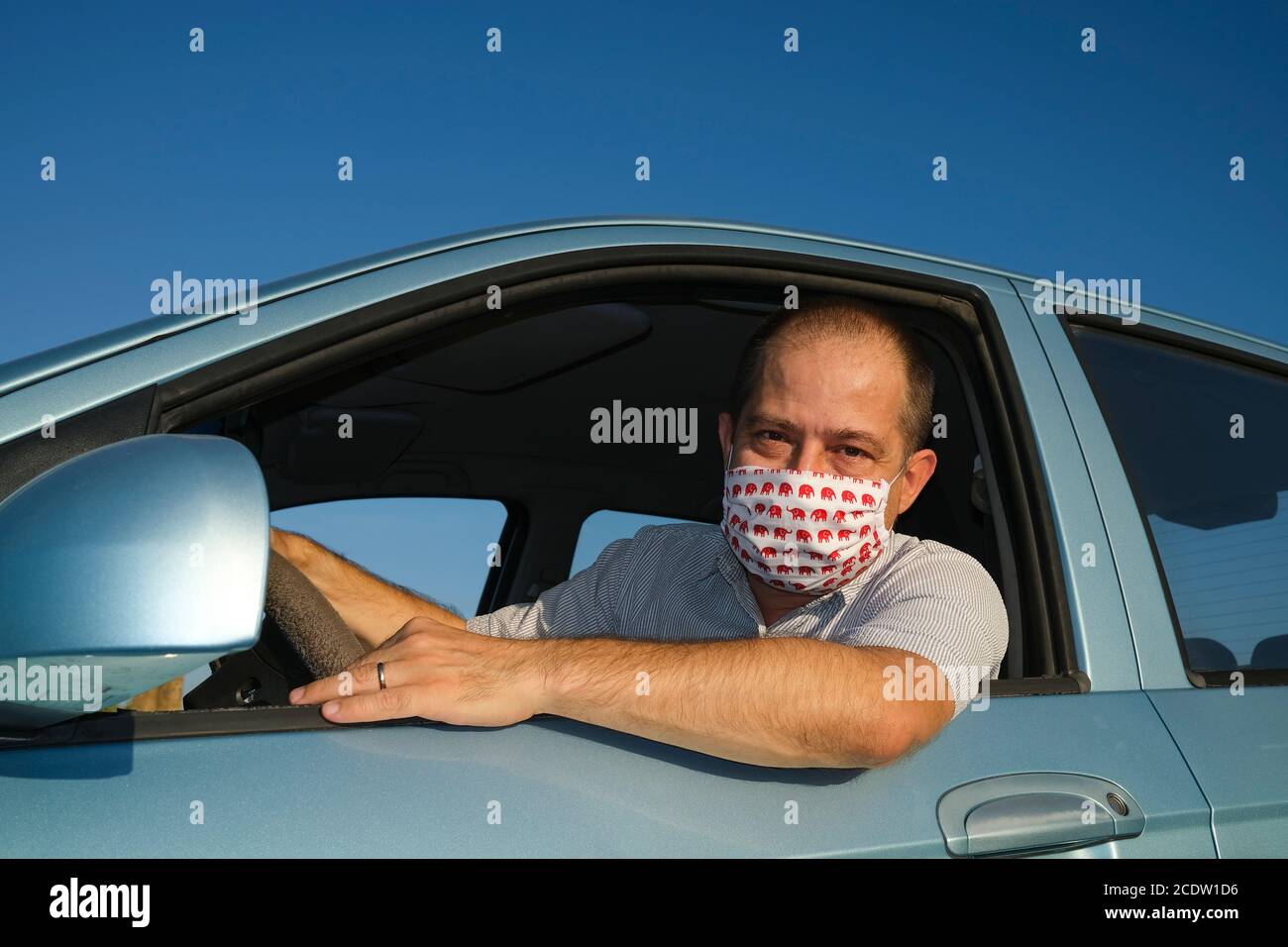 Man wearing a homemade face mask in a car as a Covid19 prevention Stock ...