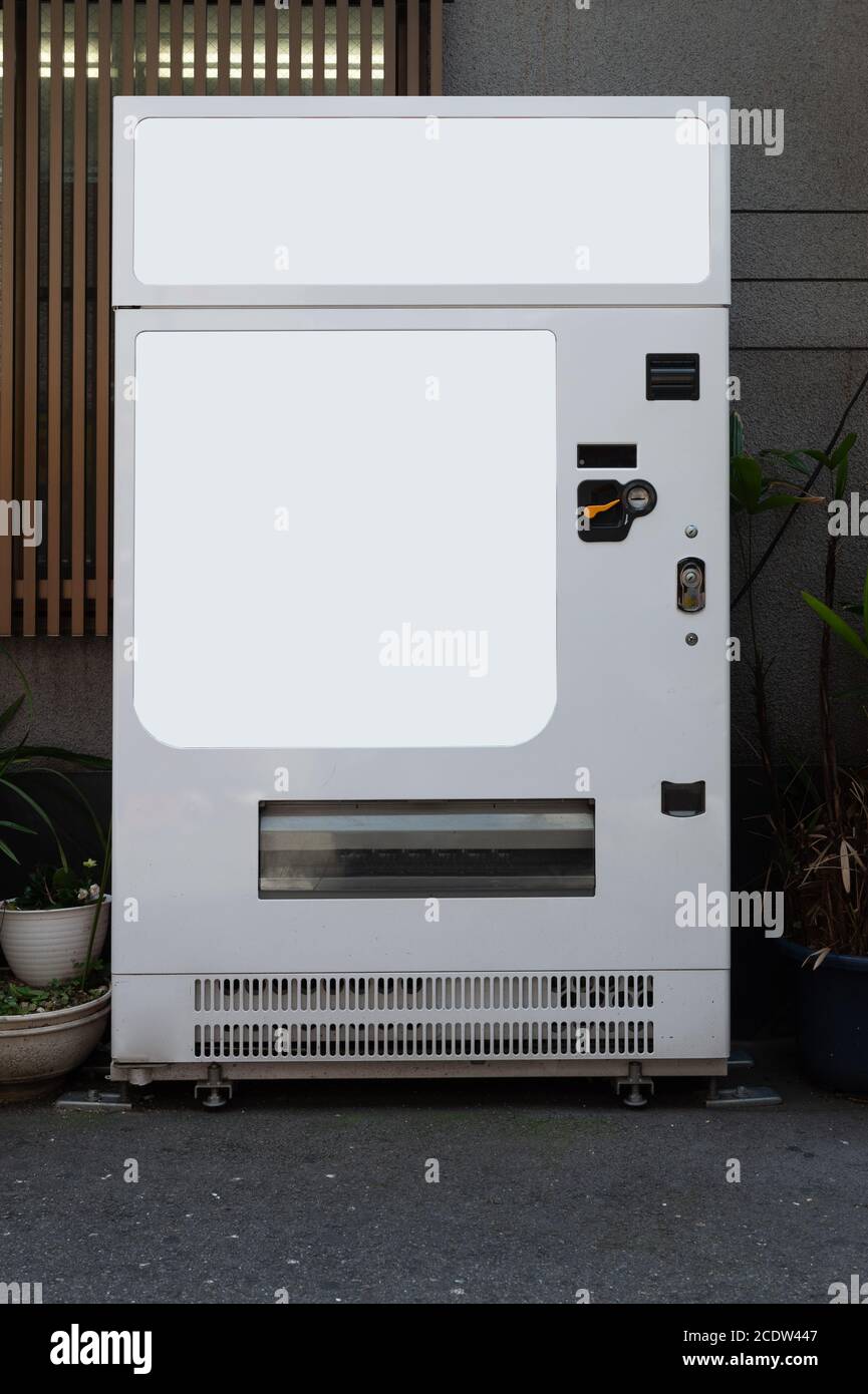 Empty white shelves of standard office vending machine Stock Photo - Alamy