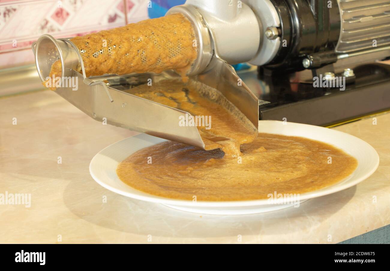 In process of making apple jam. With apple squeezer Stock Photo - Alamy
