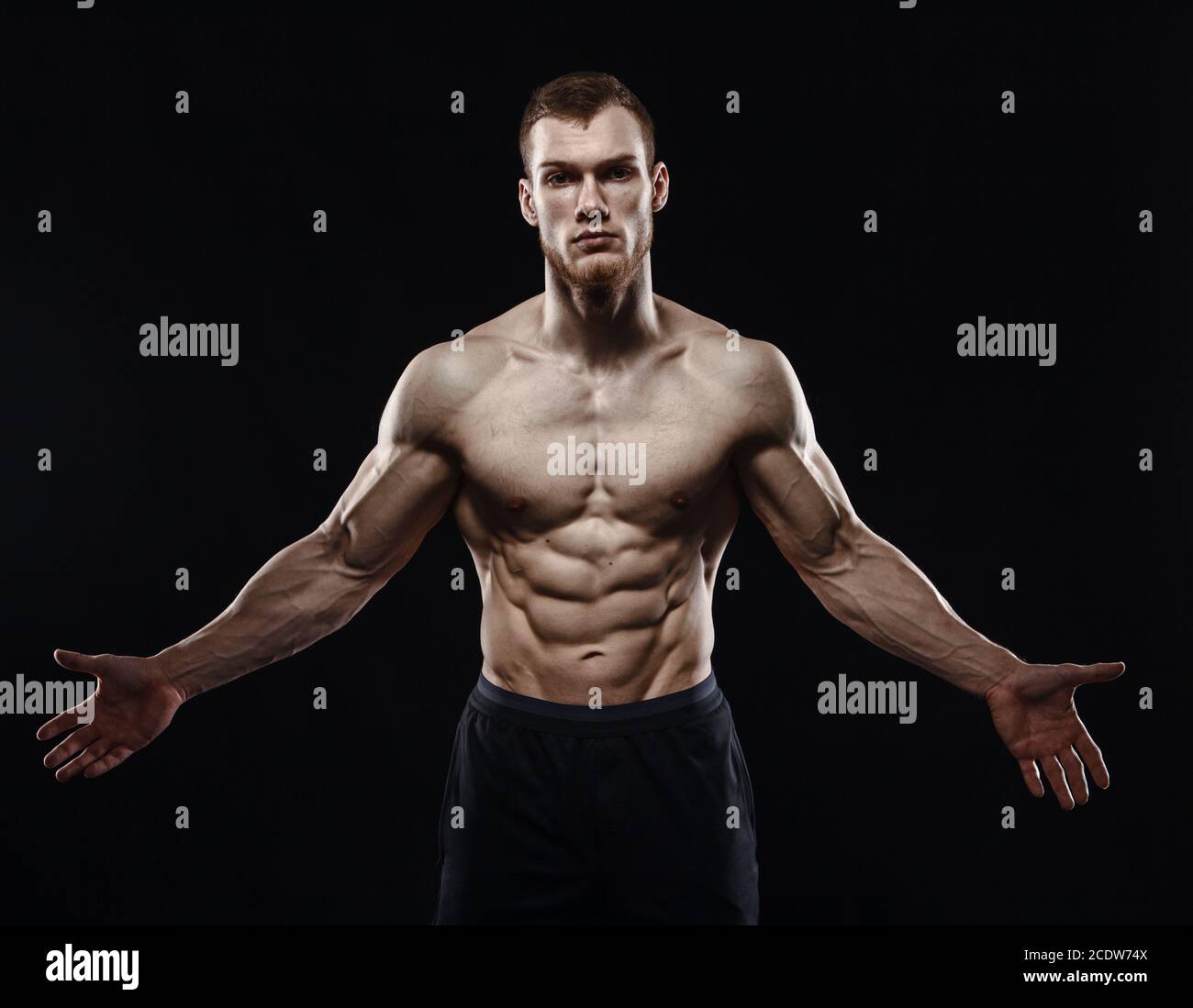 Aggressive man is a fighter, a bodybuilder on a black Stock Photo - Alamy