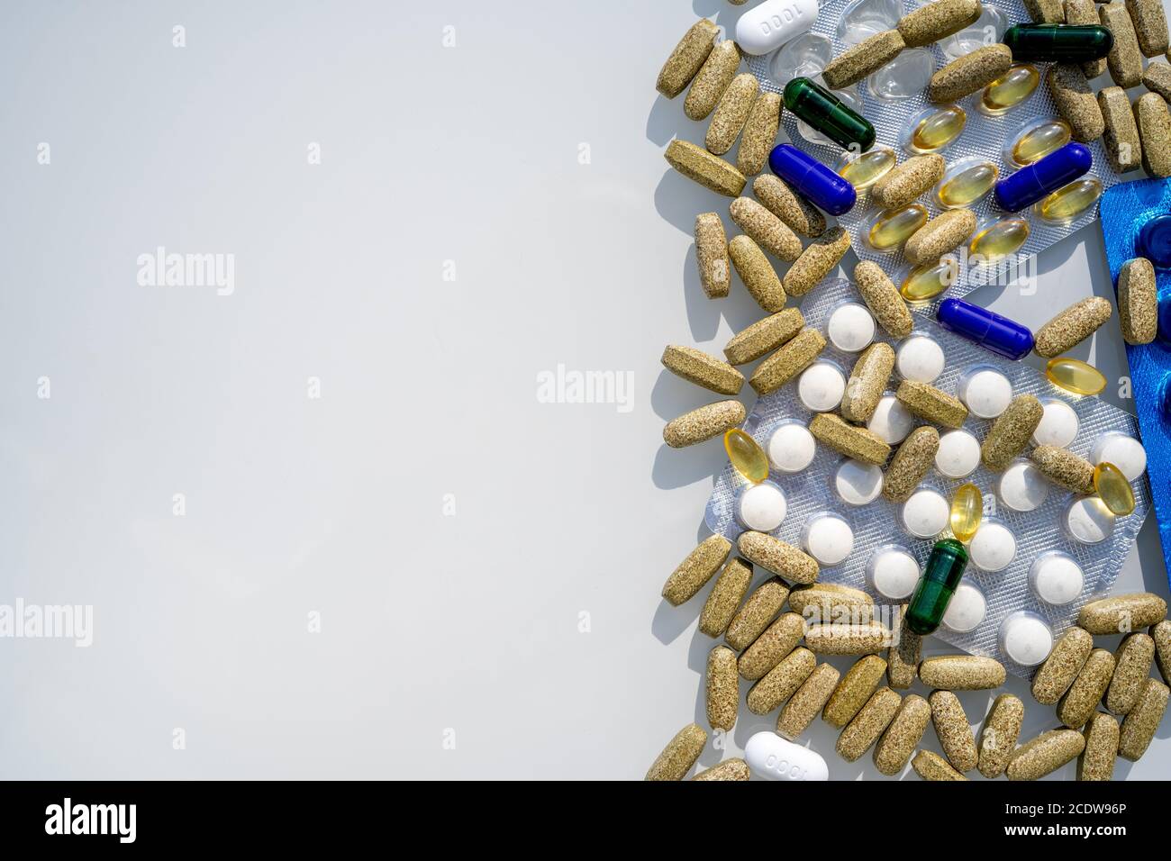 Flat lay of different pills and capsules are on the table from virus ...